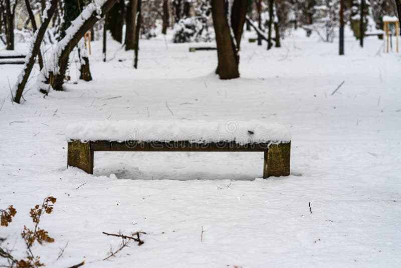 Snow-covered Bench in the Park. Park Bench Covered with Snow from the ...