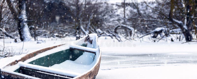 Snow-covered Boat on the River in Winter during a Snowfall Stock Image ...