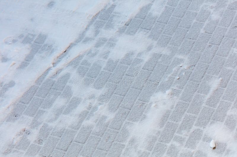 A Snow Covered Brick Wall with a Few Footprints in the Snow Stock Image ...