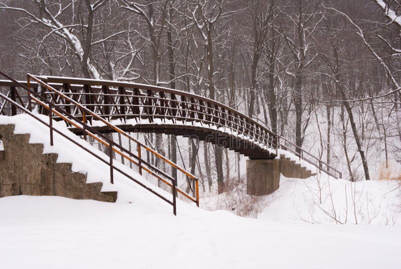 Snow Covered Brown Metal Bridge Across River in Winter Stock Photo ...