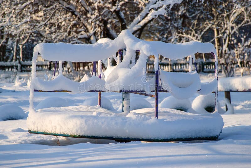 Snow Covered Carousel in the Park Stock Photo - Image of seesaw, cold ...