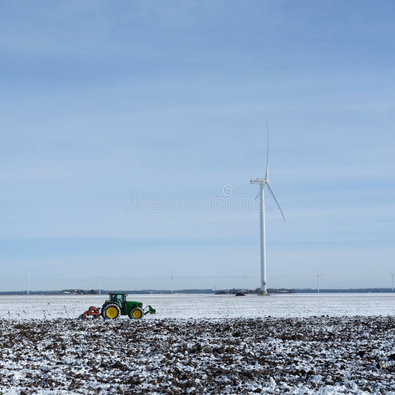 Snow Covered Fields and Tractor in Dutch Polder of Flevoland Under Blue ...