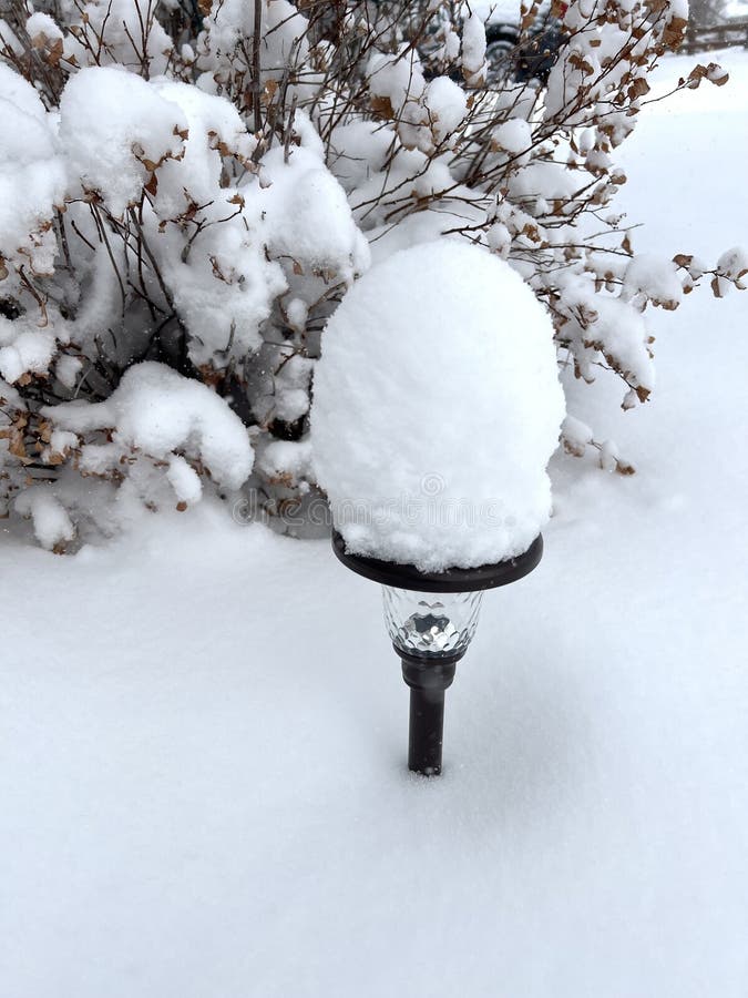 A Snow Covered Fire Hydrant Stands in the Snow Outside Stock Photo ...