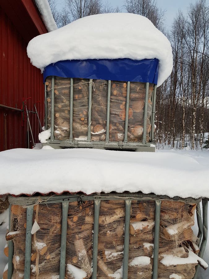 Snow Covered Firewood Stacks Outside in the Cold Arctic Circle ...