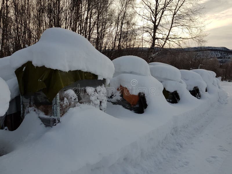 Snow Covered Firewood Stacks Outside in the Cold Arctic Circle ...