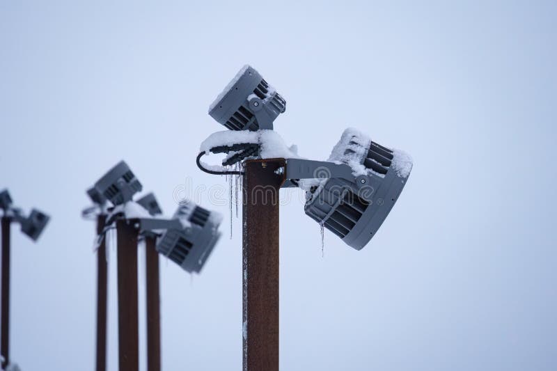 Snow-covered Light Fixtures on Poles in a Winter Stock Photo - Image of ...