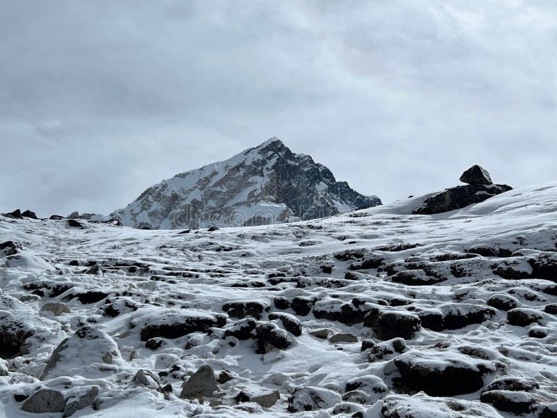 Snow-covered Mountain Peak with Cloudy Sky Stock Image - Image of ...