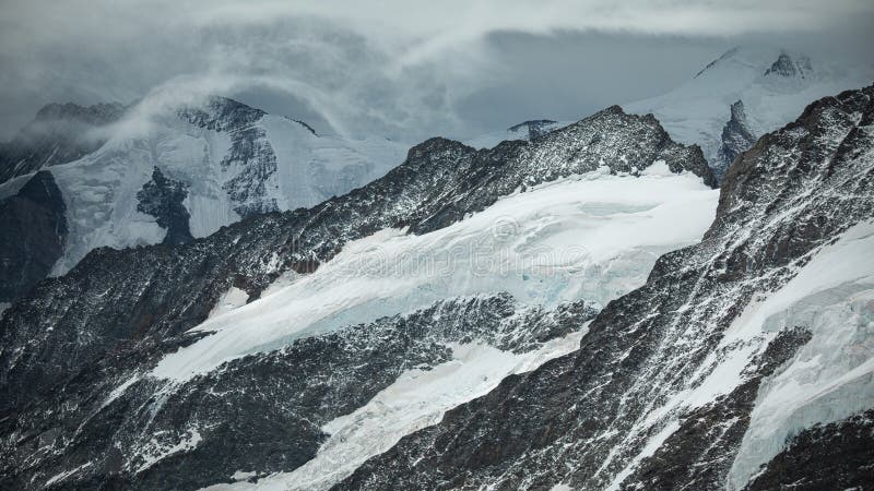 Snow-covered Mountain Range with Low-hanging Clouds Editorial Stock ...