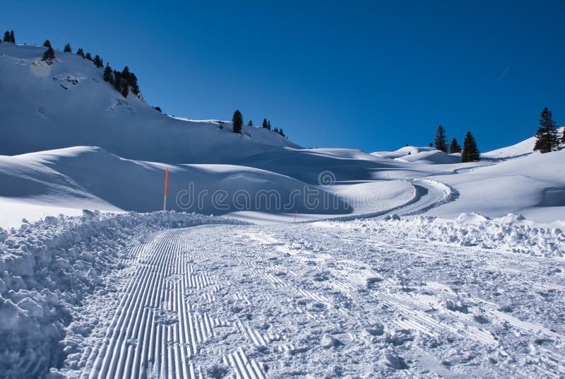 A Snow Covered Mountain with a Ski Run Down the Side Stock Photo ...