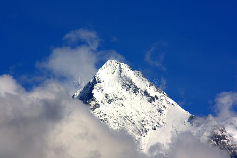 Snow covered mountain tip stock image. Image of challenge - 16063437