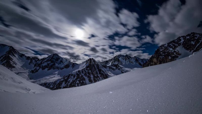 Snow-covered Mountains Under Cloudy Night Sky with Moonlight, Serene ...