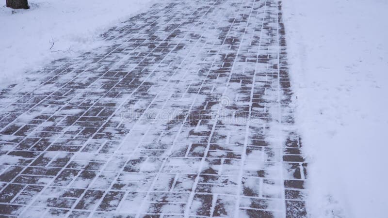 Snow-Covered Park Pathway with Cleared Footprints in Winter Stock Video ...