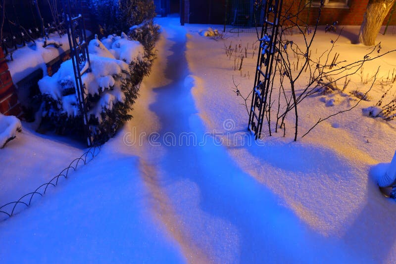 Snow Covered Path Lit by Street Lights at Night Time. Stock Image ...