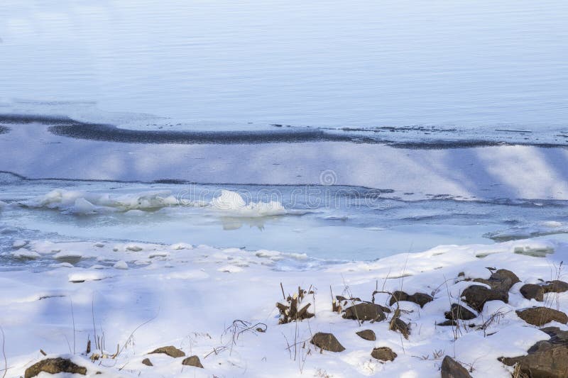 Snowcovered Rocks on River Bank. Ice and Snow Along the River Bank ...