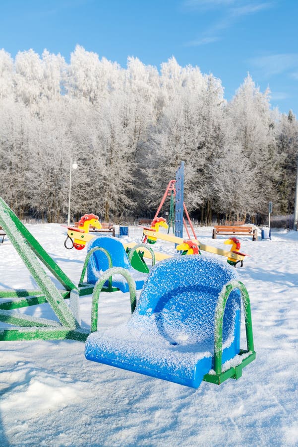 Snow Covered Swing and Slide at Playground Stock Photo - Image of ...