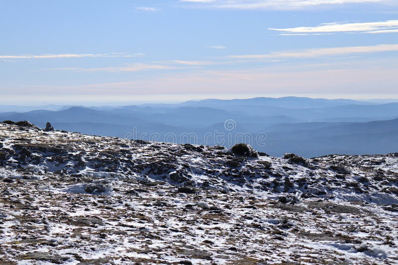 Snow-covered Terrain with Mountains in the Background Stock Photo ...