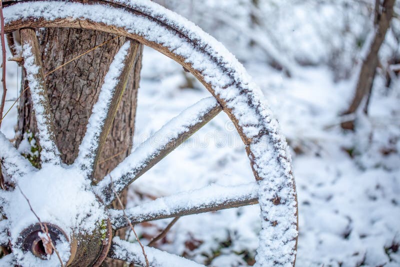 Snow-Covered Wagon Wheel in Rustic Winter Scene Stock Image - Image of ...