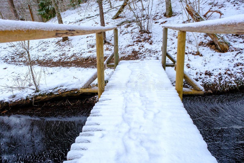 Snow-covered Wooden Bridge Over a Small River. Stock Image - Image of ...
