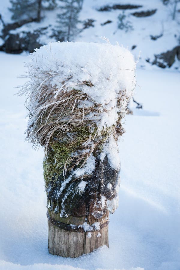 Snow covered wooden pole stock photo. Image of frozen - 96425152