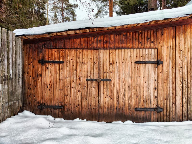 Snow-covered Wooden Shed with Sturdy Iron Hardware in a Tranquil Forest ...