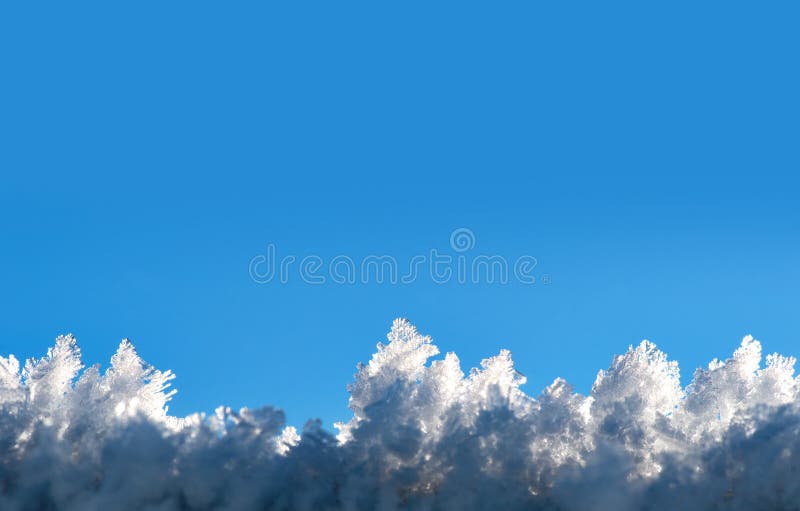 Snow crystals on blue sky stock photo. Image of snow - 28850906