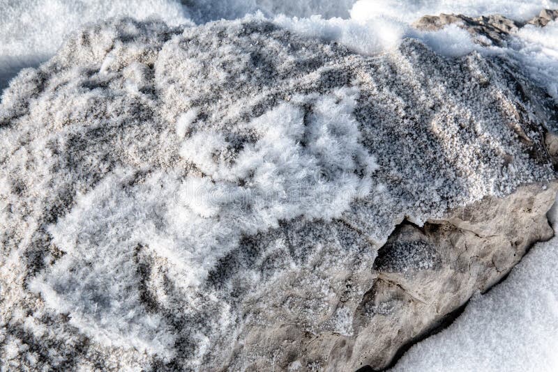 Snow crystals on a rock stock image. Image of beauty - 77290687