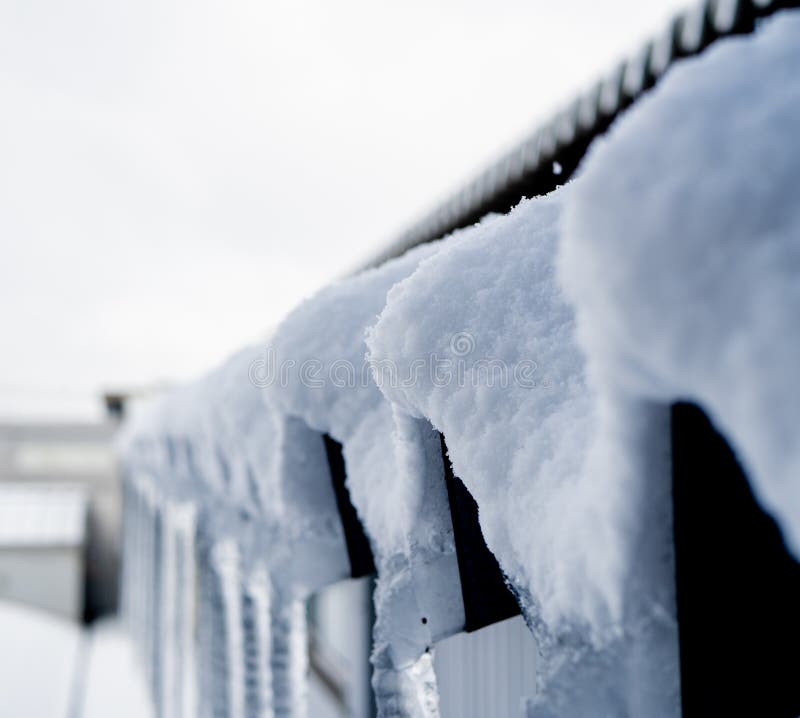 Snow curtain at the eaves. stock image. Image of architecture - 162377877
