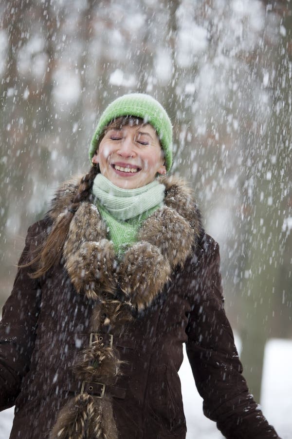 Snow falling on woman stock image. Image of flakes, happiness - 12418821