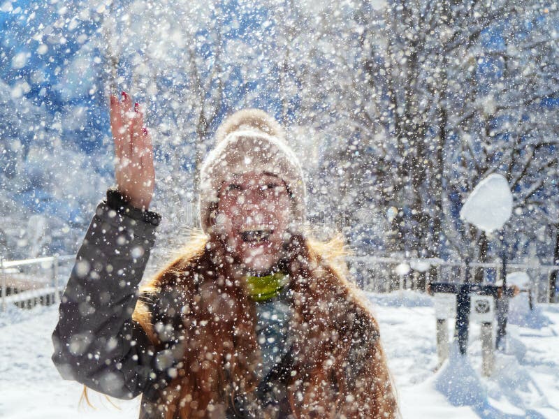 Snow Falls from Above on a Joyful Girl Illuminated by the Sun Stock ...