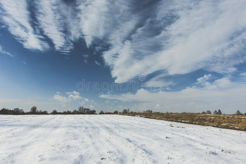Snow on the Field and Fancy White Clouds on the Sky Stock Image - Image ...