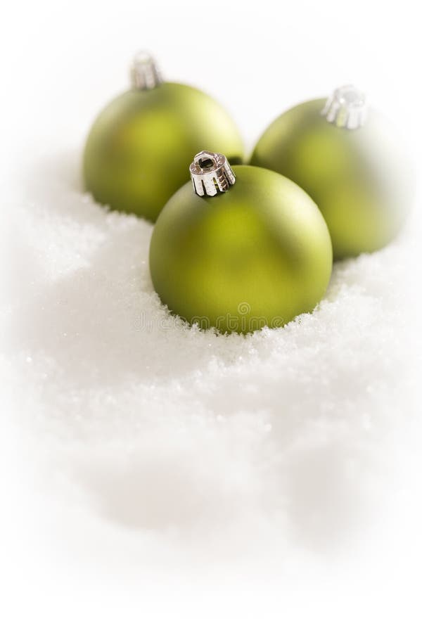 Green Christmas Ornaments on Snow Over a Grey Background Stock Photo ...