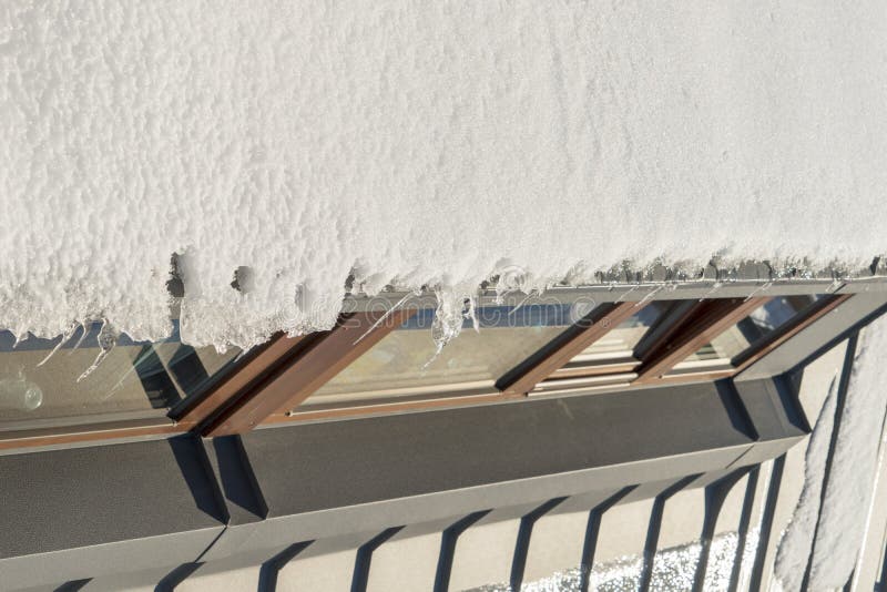 Snow hanging on the roof stock image. Image of frozen - 83177735
