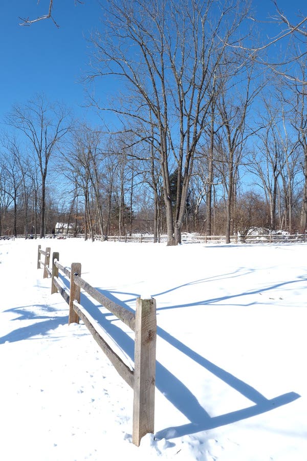 The Snow Has Fallen in the Park and the Fence Casts a Shadow. Stock ...