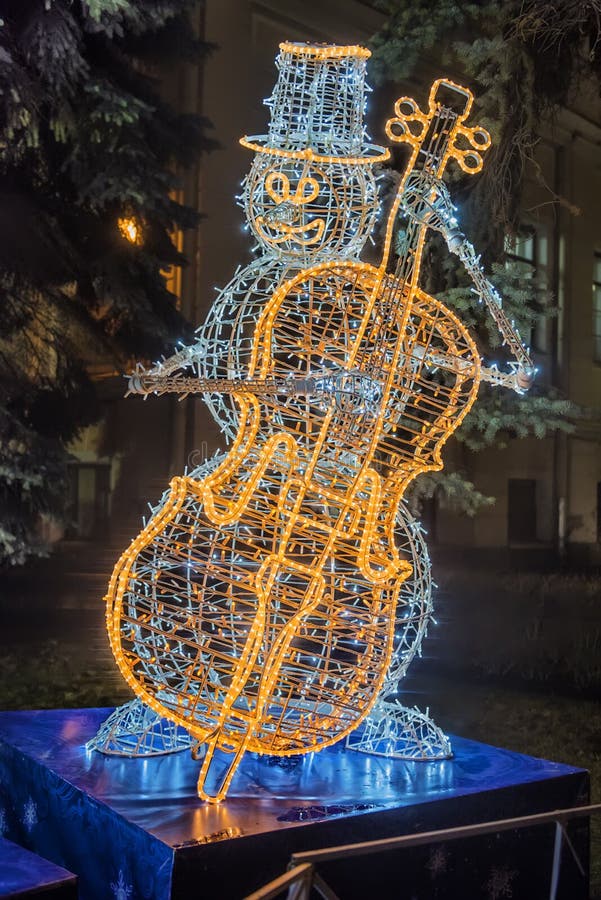 Snow man with a cello stock photo. Image of light, broomstick - 84278958