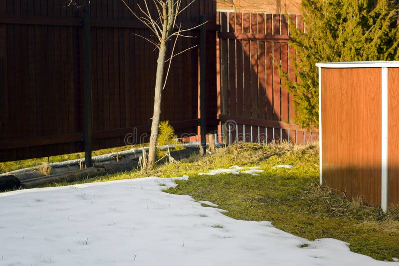 Snow melting in a backyard stock photo. Image of landscape - 174073456