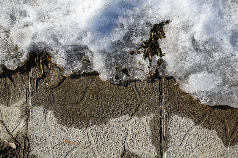 Snow is Melting on the Paving Slabs. Spring Concept Stock Photo - Image ...