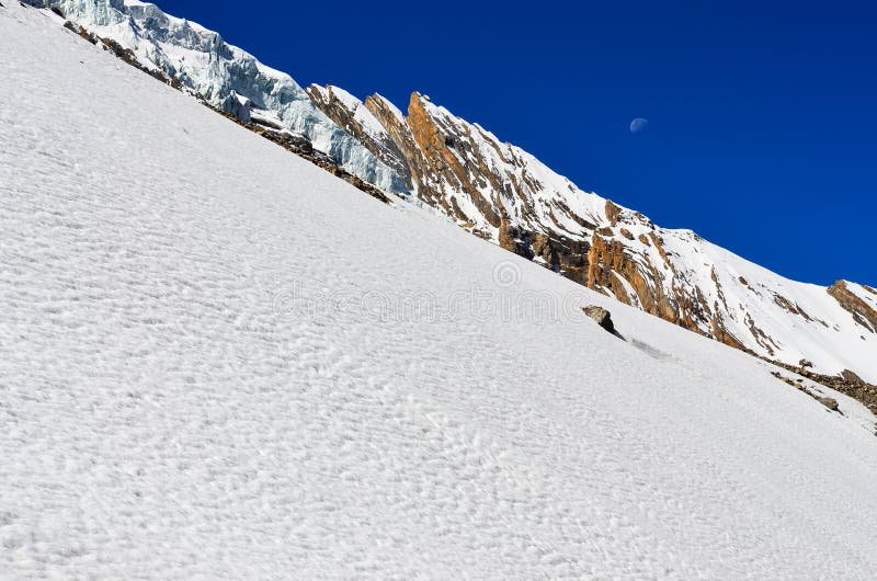 Snow Mountain Slope with Rocks, Glacier and Blue Sky with Moon Stock ...