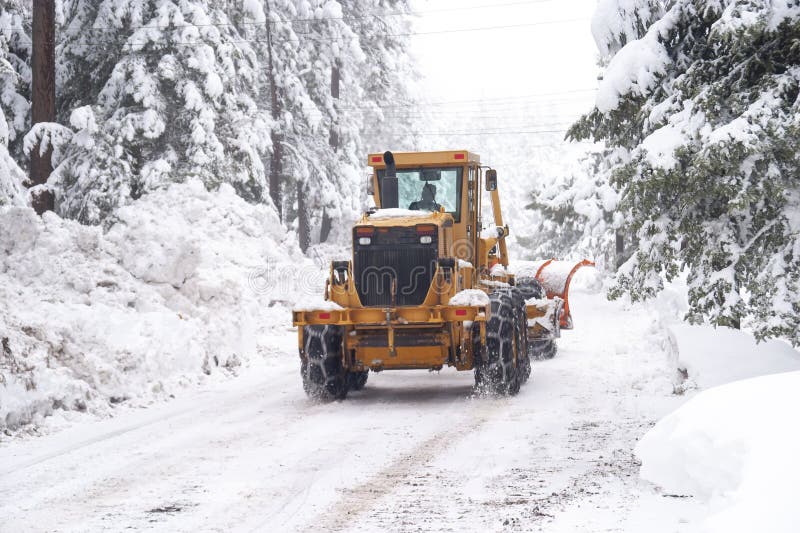 Snow Plow Tractor Working in Blizzard Conditions on a Road Stock Image ...