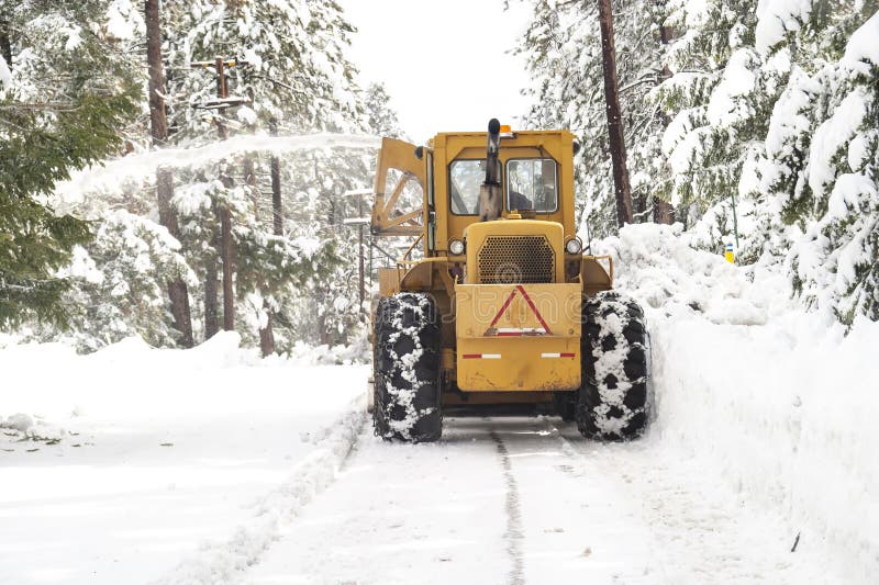 Snow Plow Tractor Working in Blizzard Conditions on a Road Stock Image ...
