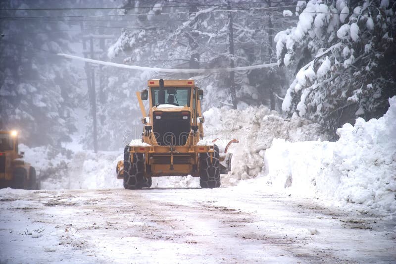 Snow Plow Tractor Working in Blizzard Conditions on a Road Stock Image ...