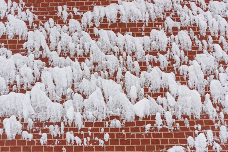 Snow on red brick wall stock photo. Image of design - 126443914