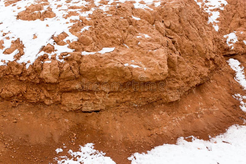 Snow on red clay in nature stock photo. Image of dirt - 109468572