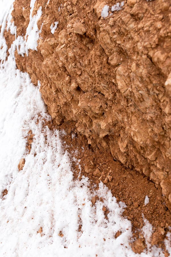 Snow on red clay in nature stock photo. Image of infertile - 109468666