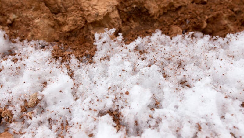 Snow on red clay in nature stock image. Image of dryness - 109804439