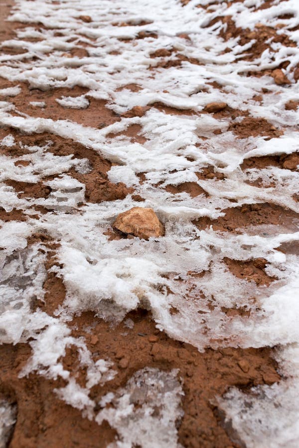 Snow on red clay in nature stock image. Image of geology - 109804465