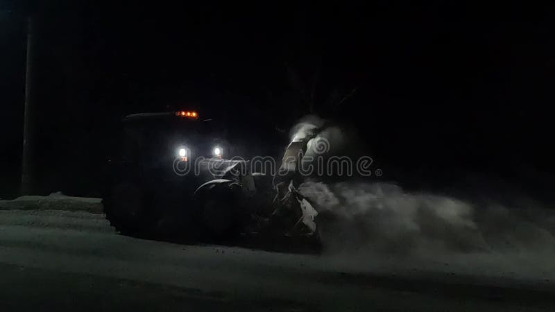 Snow Removal Equipment in the Form of a Tractor Operating at Night and ...