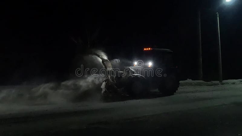 Snow Removal Equipment in the Form of a Tractor Operating at Night and ...