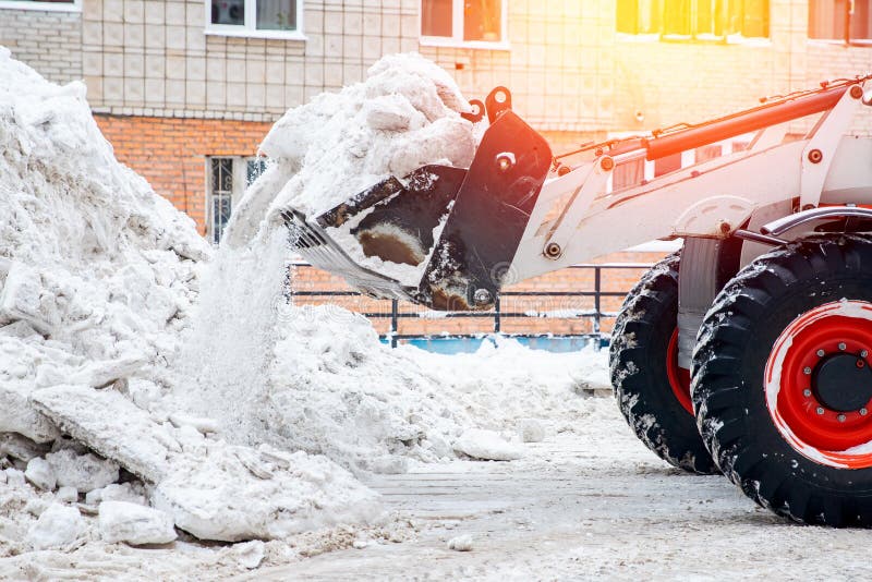 Snow Removal Excavator Tractor Cleaning on Winter Road Covered with ...