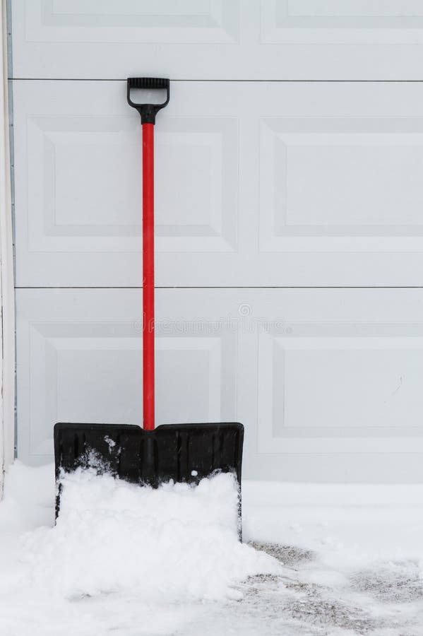A Snow Shovel Against Garage Door Stock Image - Image of garage ...