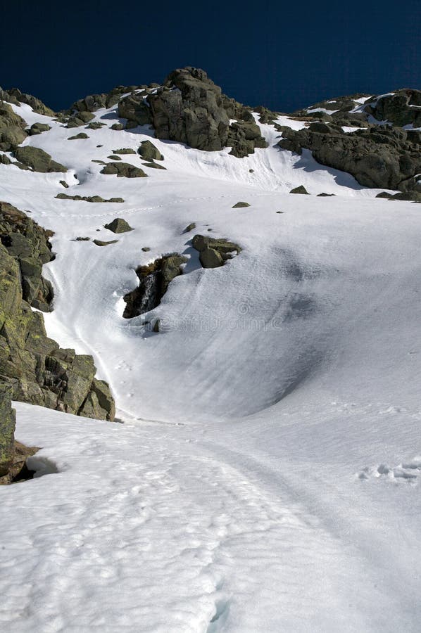 Snow slope with big rocks stock image. Image of snow - 10522111